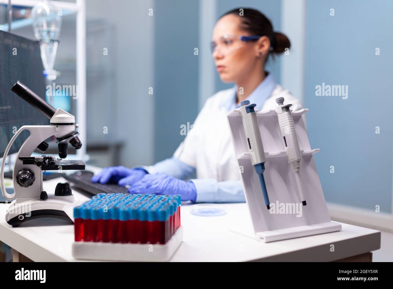 Microbiology scientist typing biochemistry discovery experiment at ...