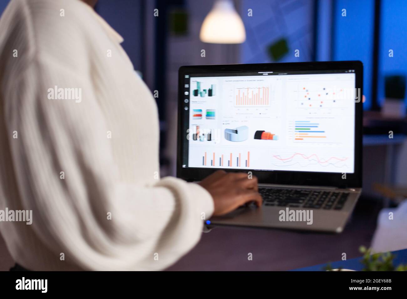 Overworked businesswoman typing financial statistics hi-res stock ...