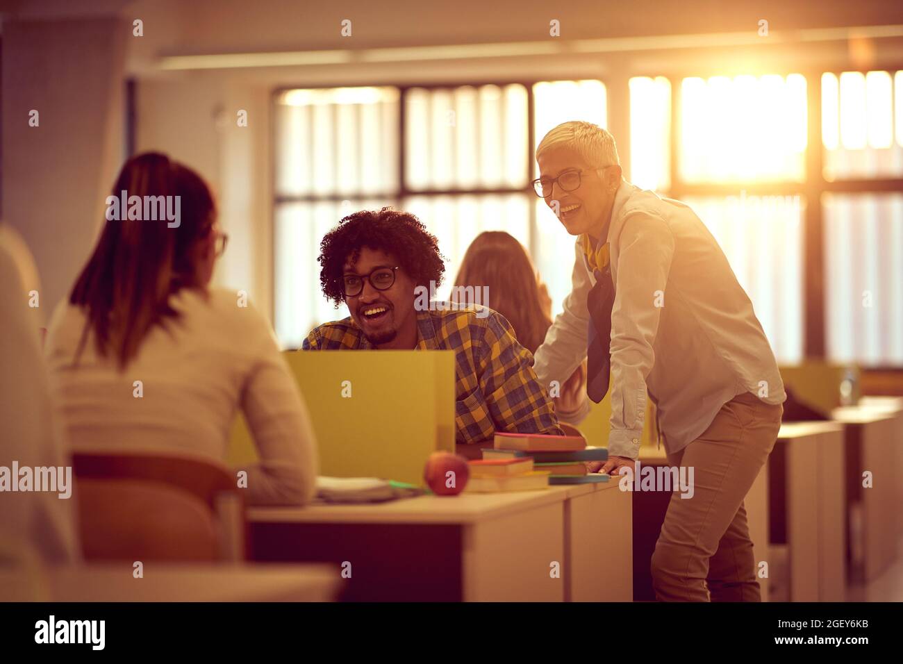 Students and professor enjoying a talk about lesson at a lecture in the ...