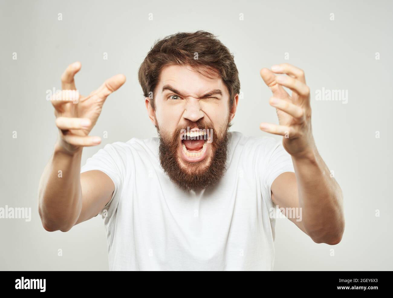 emotional man in a white t-shirt expressive look discontent close-up ...