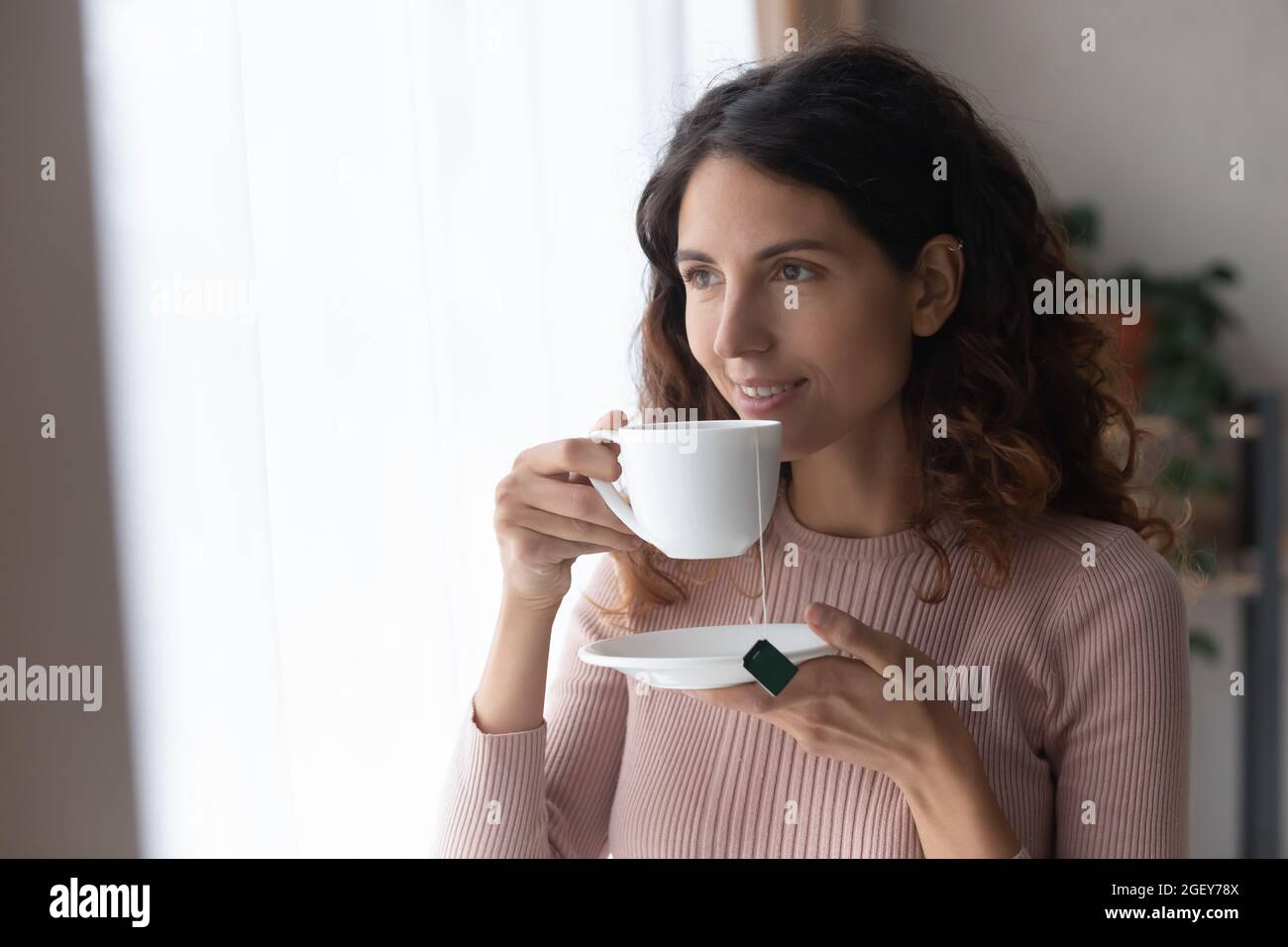 Woman tea cup smile indoor hi-res stock photography and images - Alamy