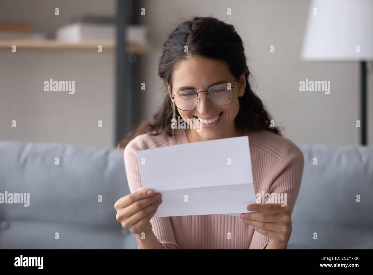 Woman on sofa reading letter hi-res stock photography and images - Alamy