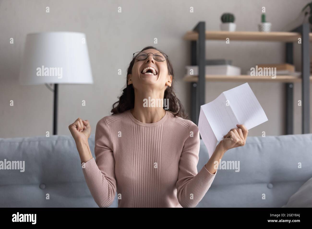 Woman feels excited by good news written in letter Stock Photo - Alamy