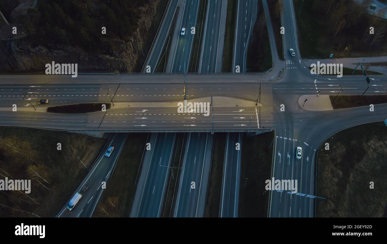 Aerial view of a junction with road markings at night. Bridges, roads ...