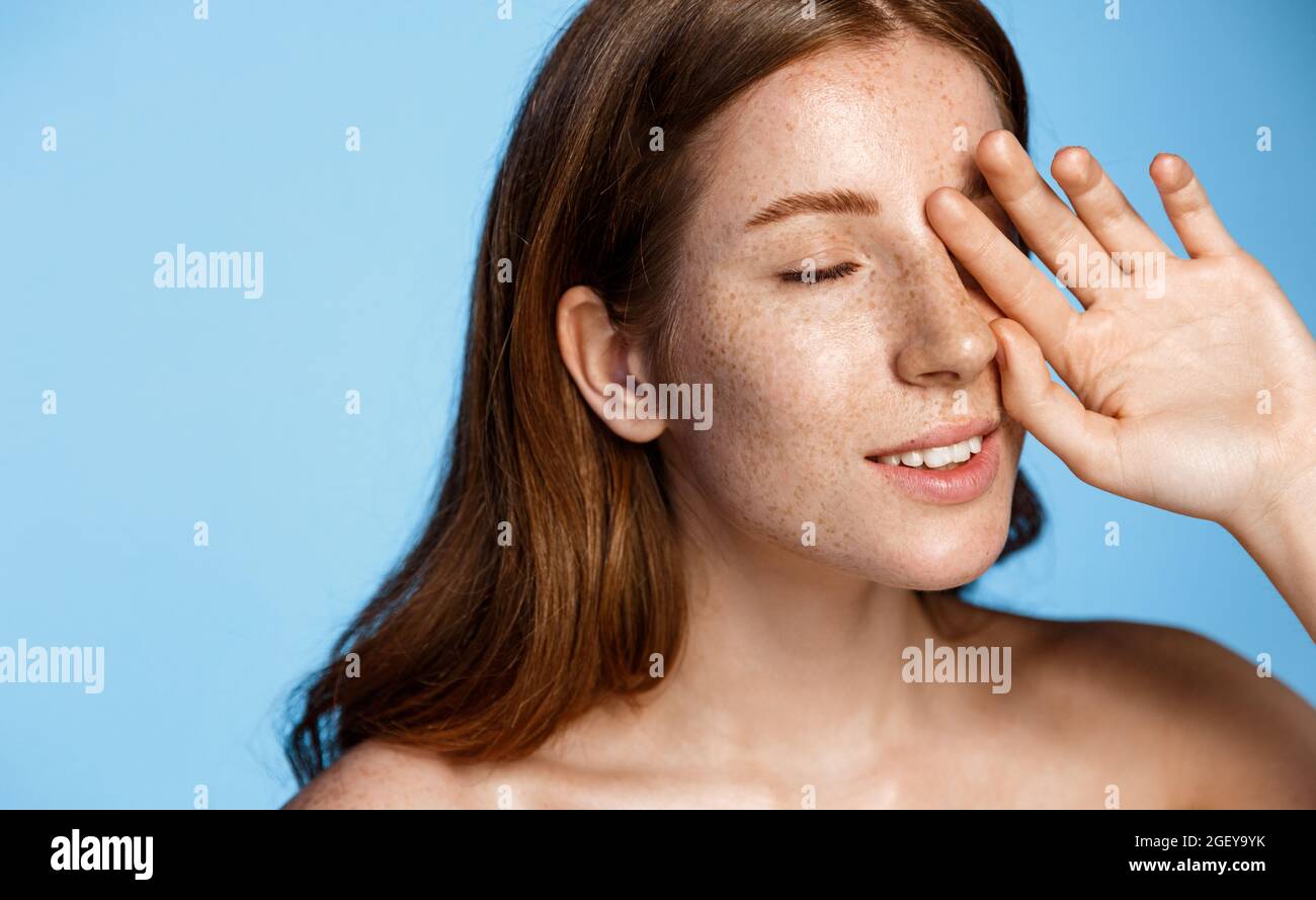 Beauty face. Redhead girl with natural clean face with freckles, gently ...