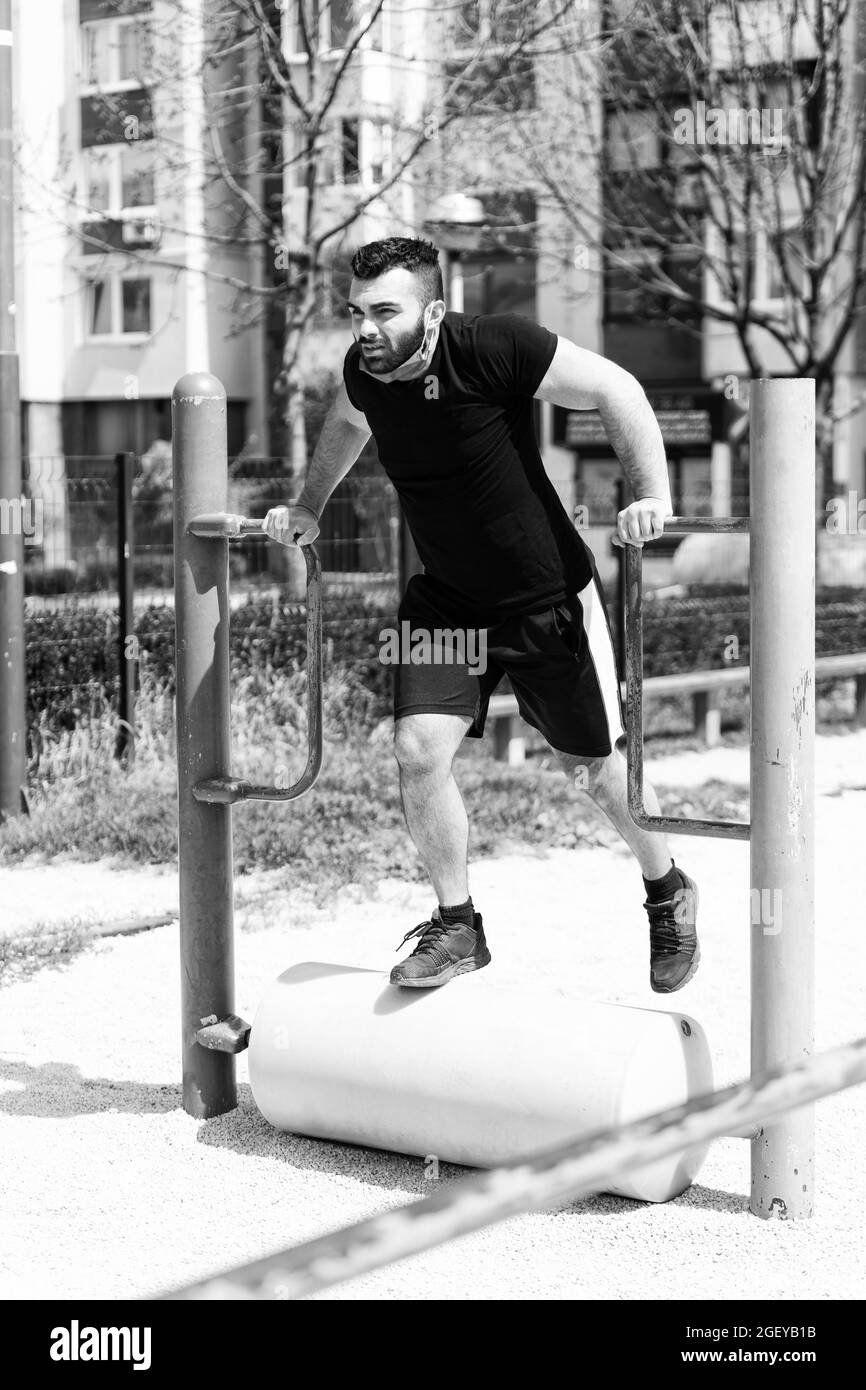 Young Athlete Working Out Triceps In An Outdoor Gym - Doing Street ...