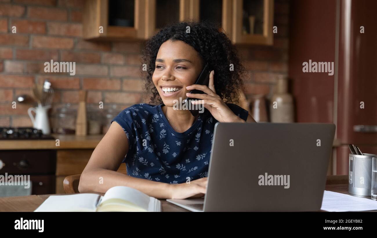 Happy millennial African mixed race student girl speaking on cell Stock ...