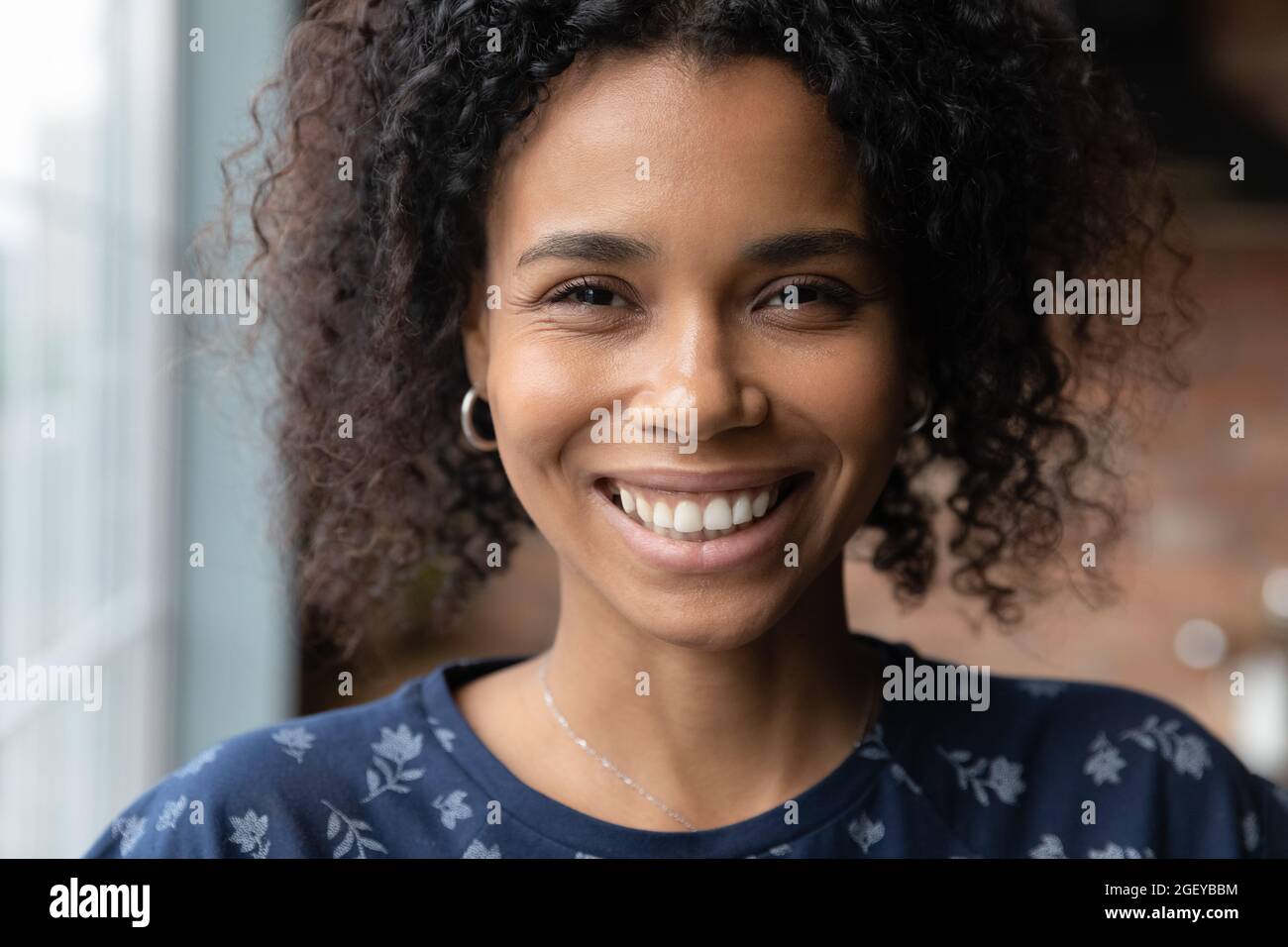 Happy African woman with fine face skin looking at camera Stock Photo ...