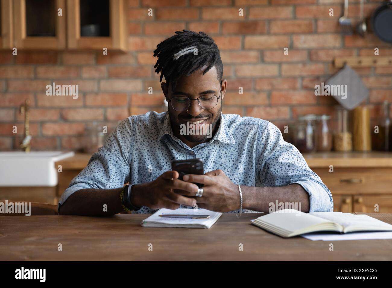 Young man checking text messages hi-res stock photography and images ...