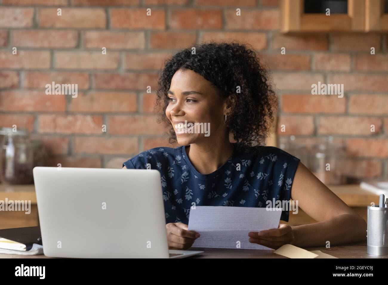 Happy millennial Black student girl receiving paper letter, invitation ...