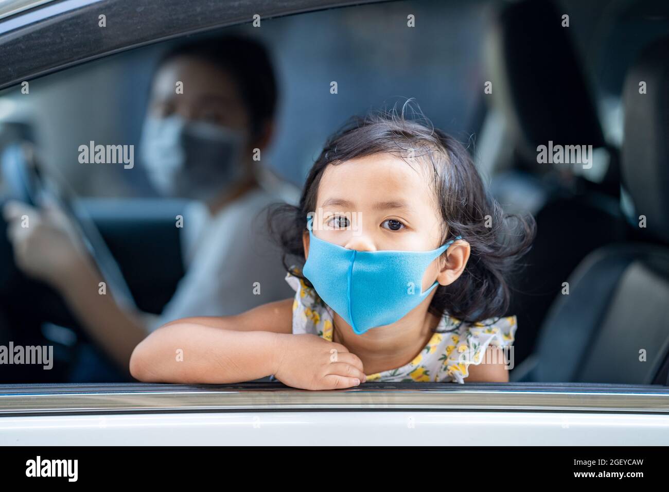 A mother and daughter wearing a medical disposable face mask Stock ...