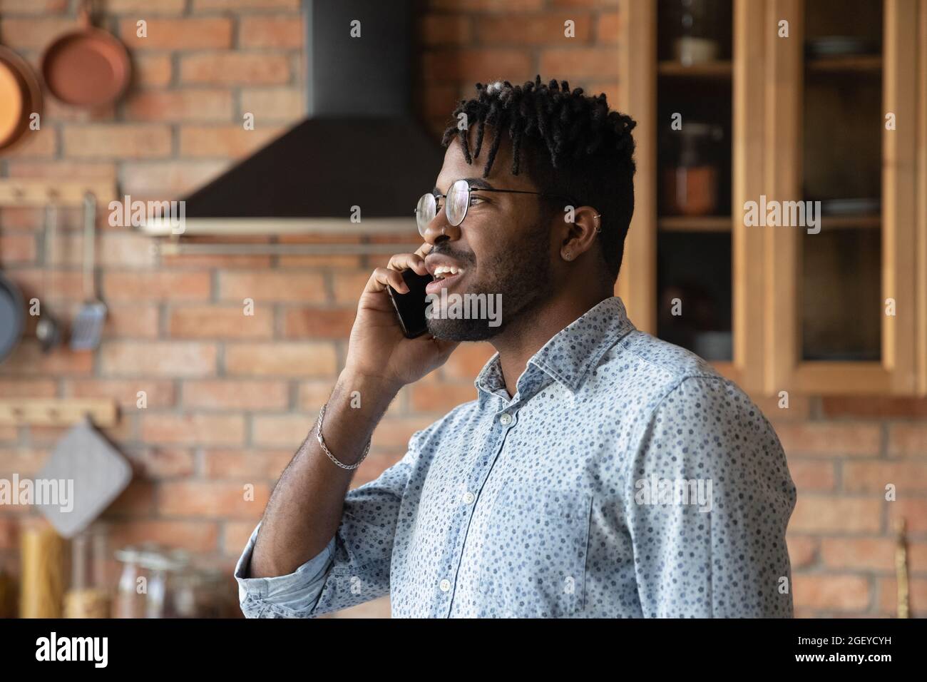 Handsome millennial African American hipster guy making telephone call ...