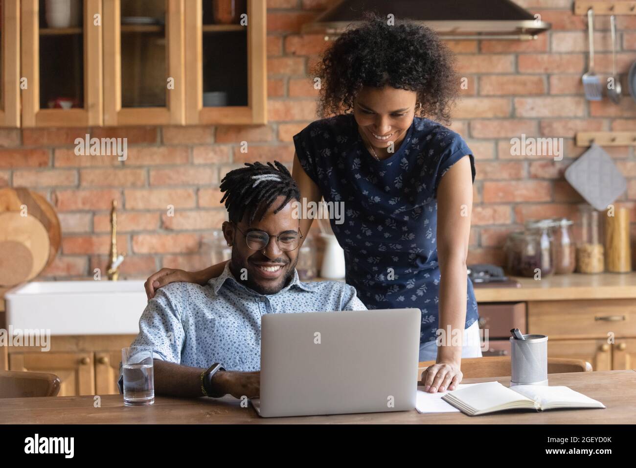 Happy African American couple watching content on laptop Stock Photo ...