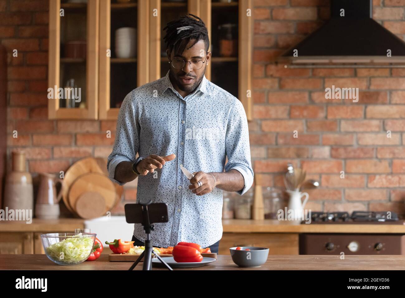 African American male food blogger shooting cooking process Stock Photo ...