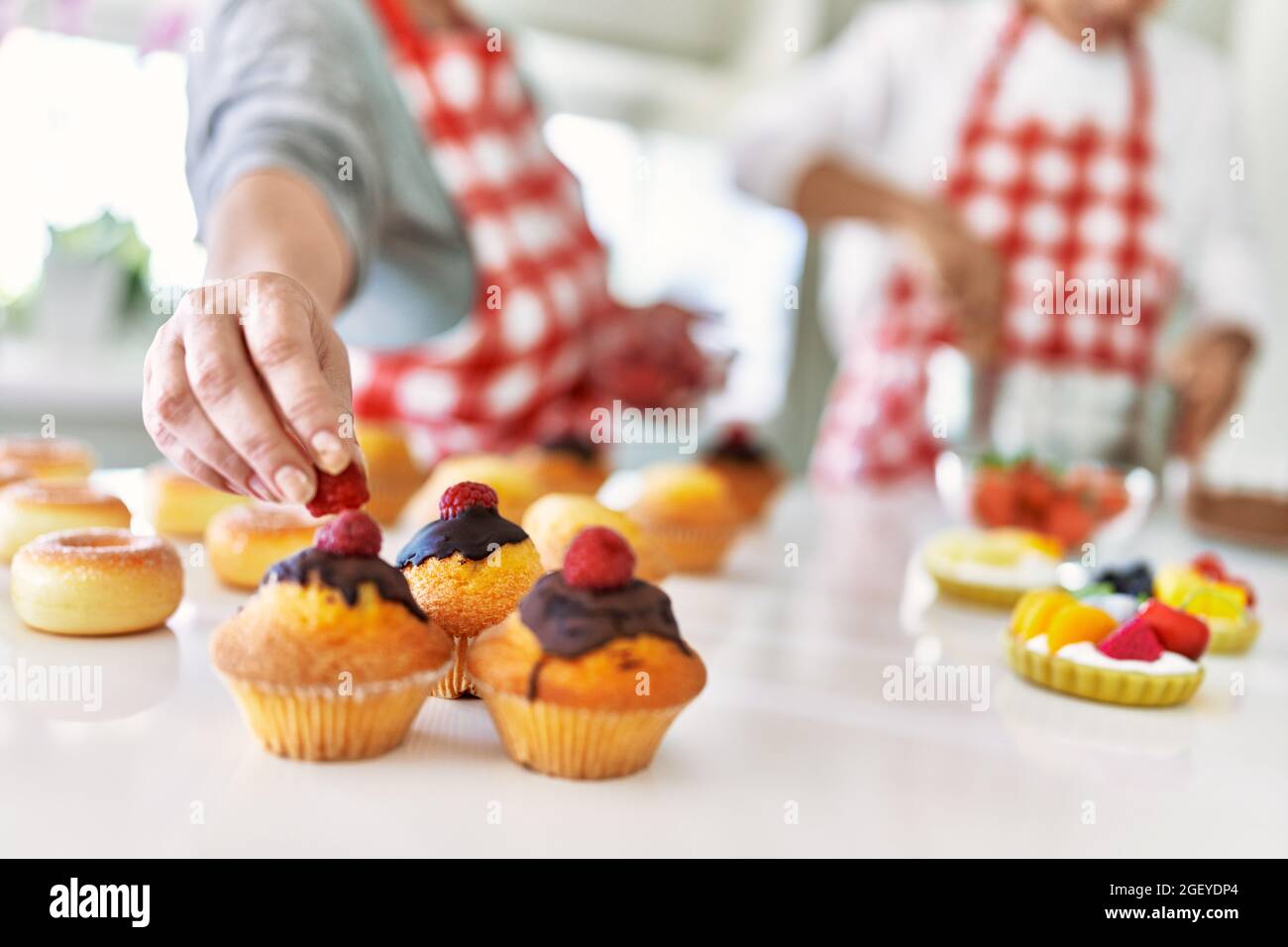 Couple cooking sweets at the kitchen Stock Photo - Alamy