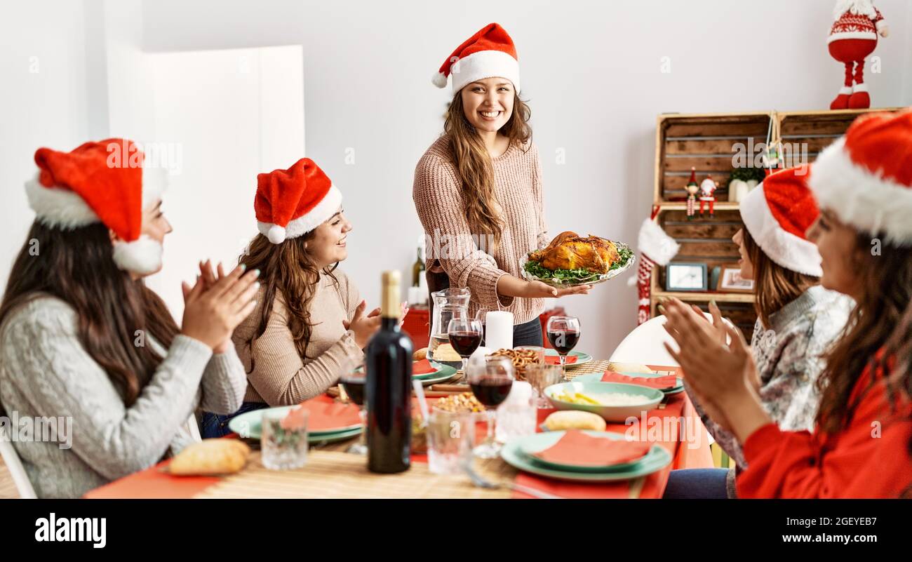 Group of hispanic women clapping and sitting on the table. Woman ...