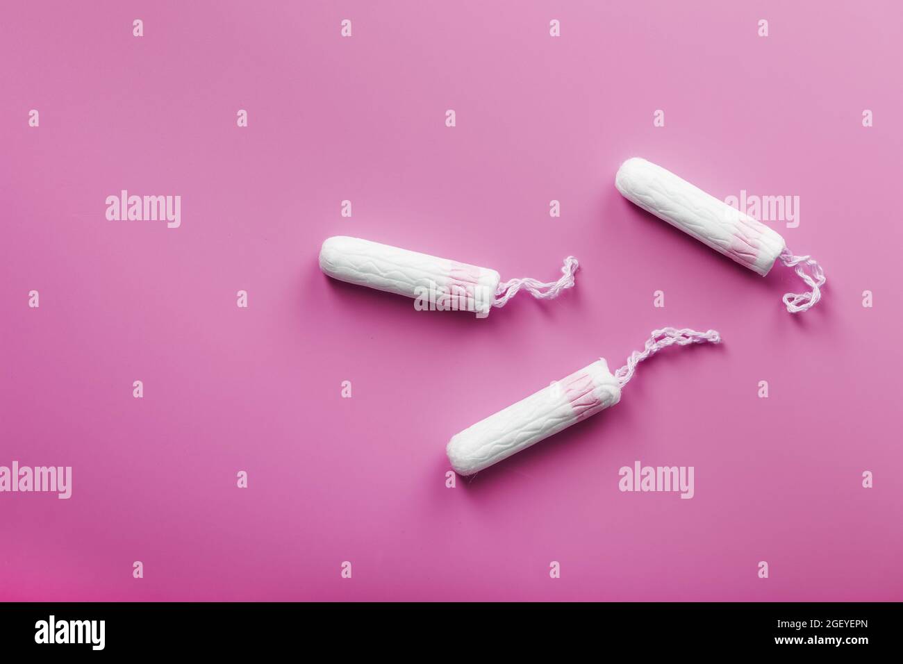 Cotton tampons on a pink background with a free space. Top view, flat ...