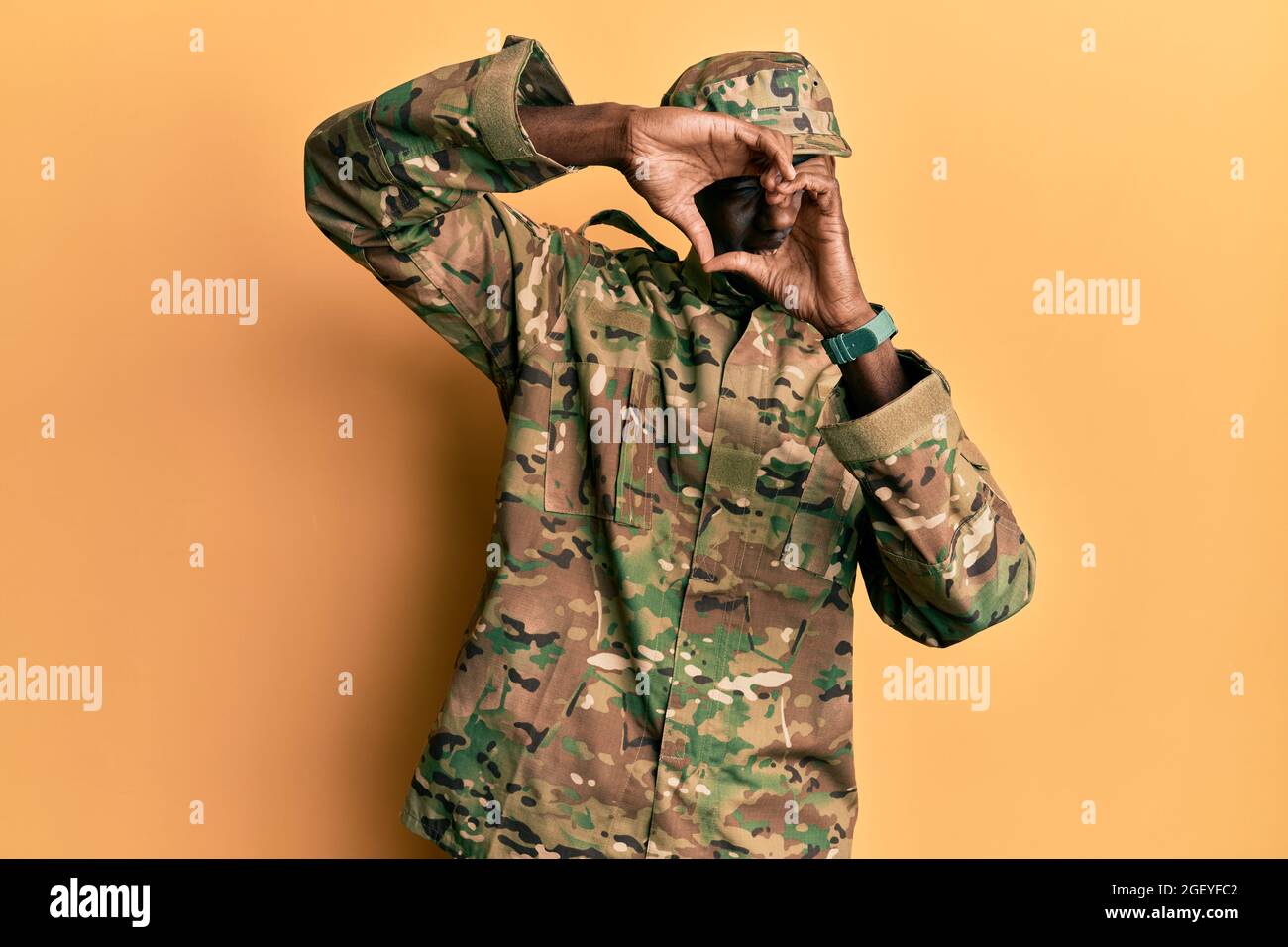 Young african american man wearing army uniform doing heart shape with ...