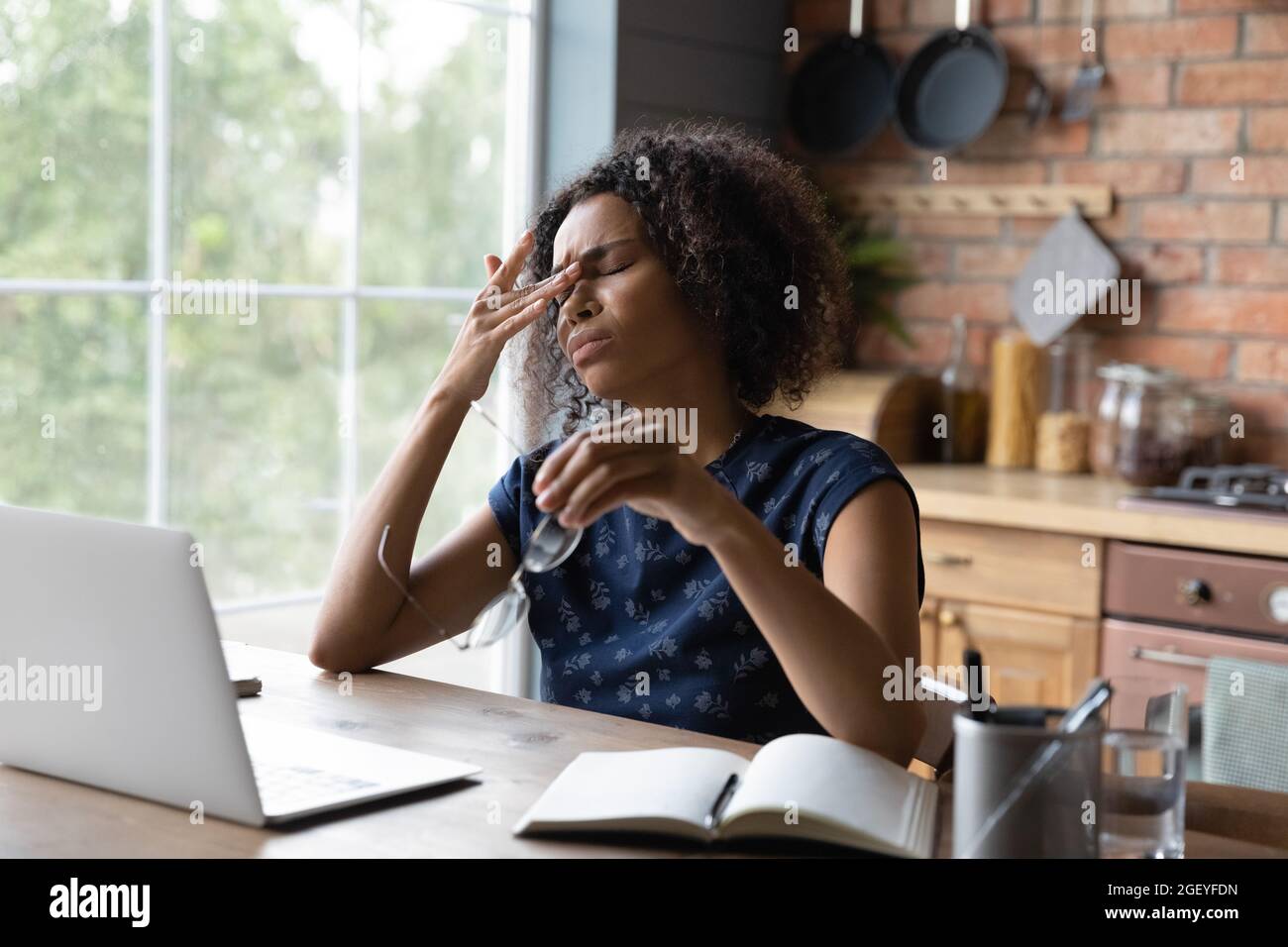 Frustrated African American remote employee tired of work at computer ...
