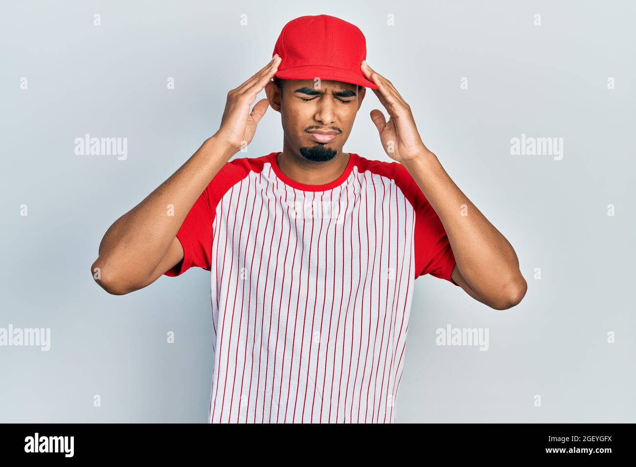 Young african american man wearing baseball uniform amazed and ...