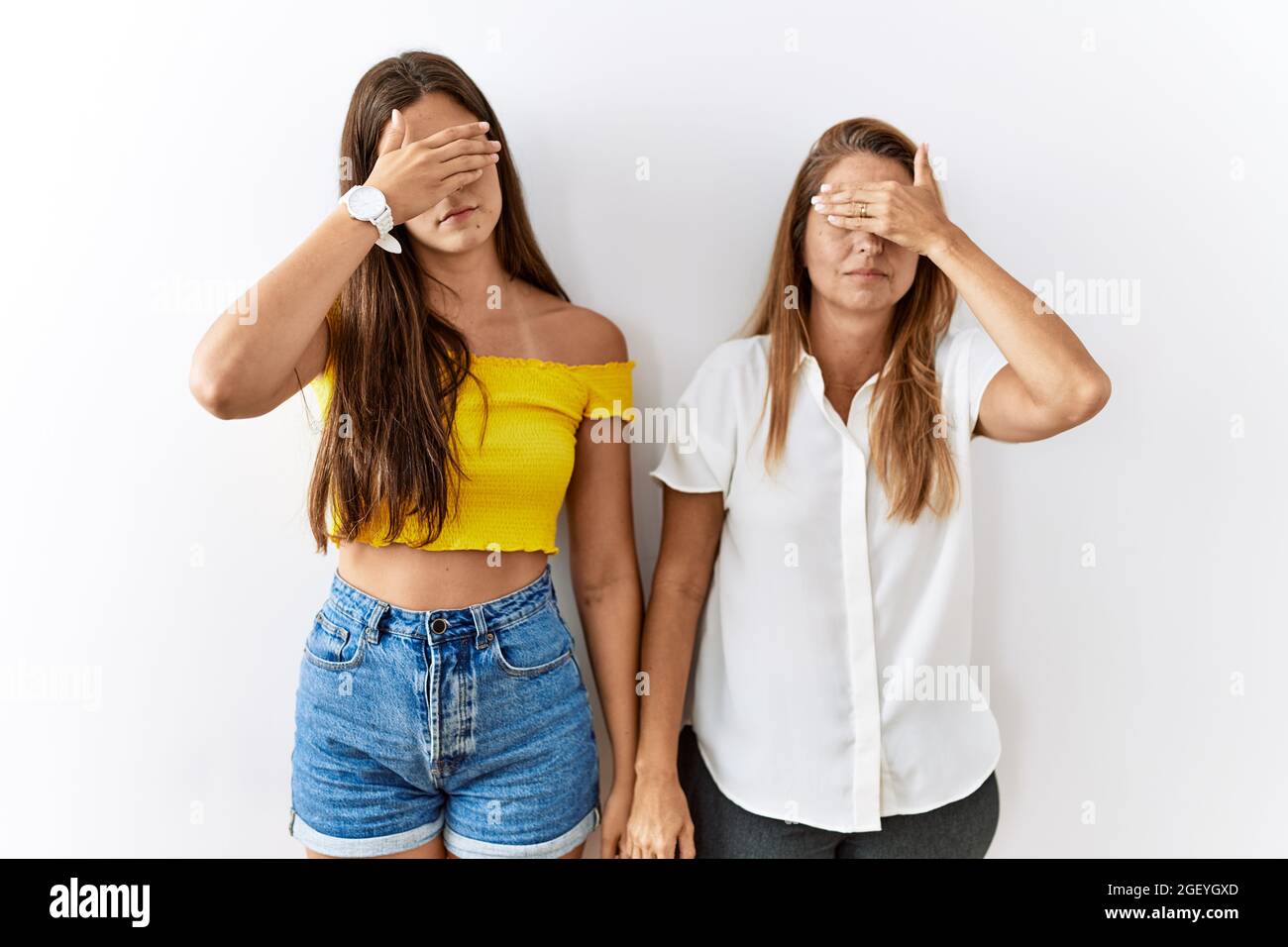 Mother And Daughter Together Standing Together Over Isolated Background