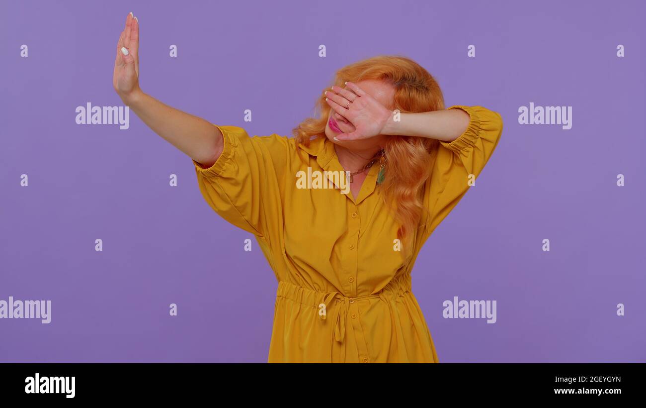 Trendy cheerful girl dancing and moving to rhythm, dabbing raising ...