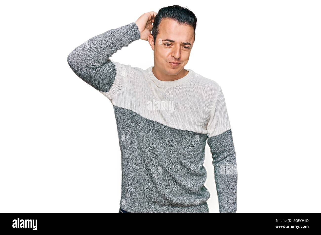 Handsome young man wearing casual winter sweater confuse and wonder ...