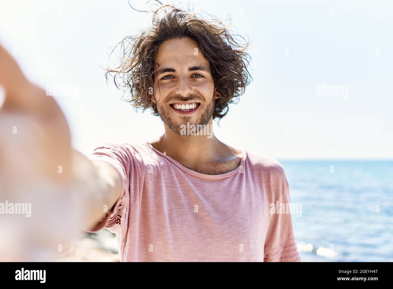 Young hispanic man smiling happy make selfie by the camera standing at ...