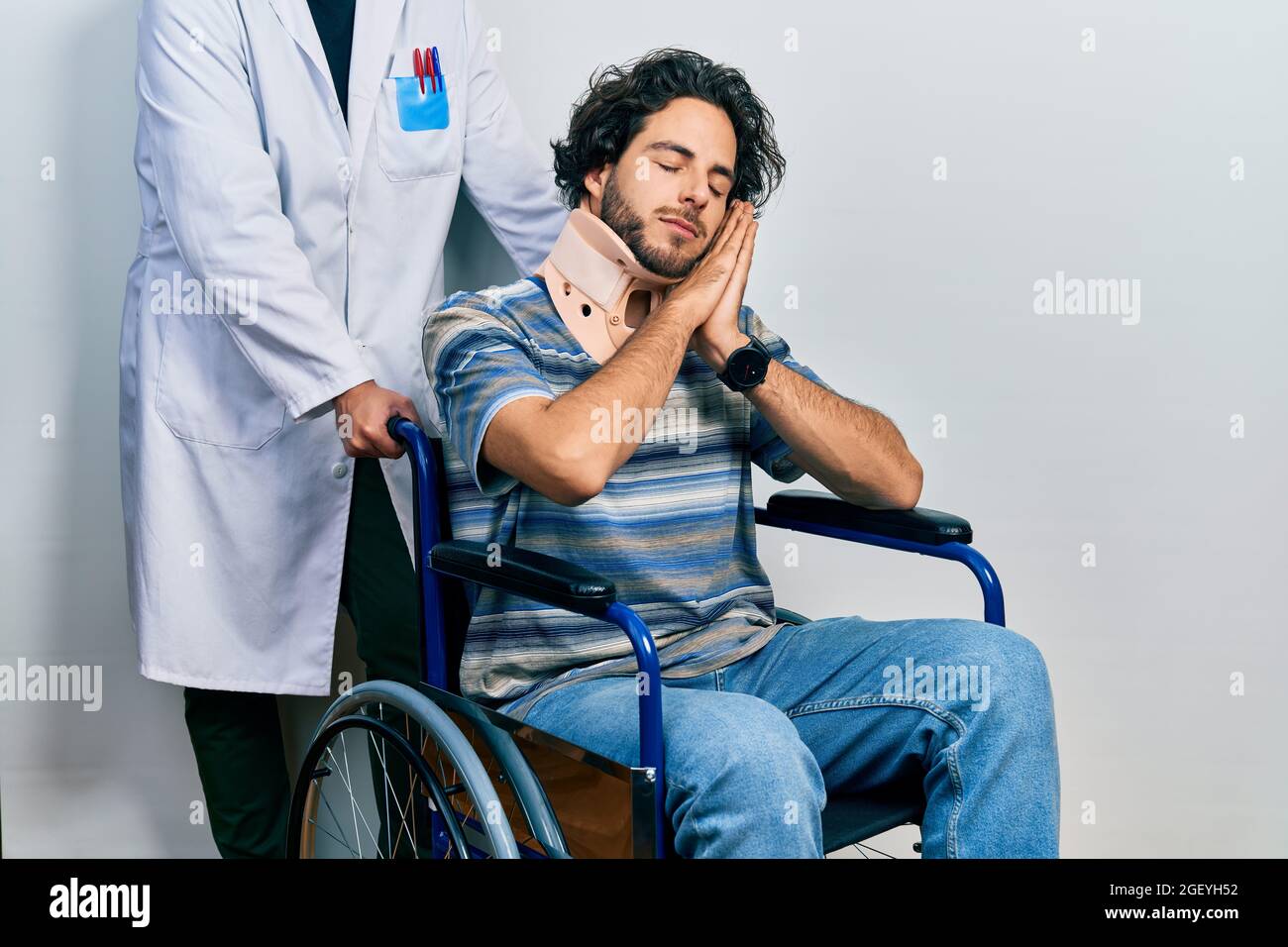 Handsome hispanic man sitting on wheelchair wearing neck collar ...