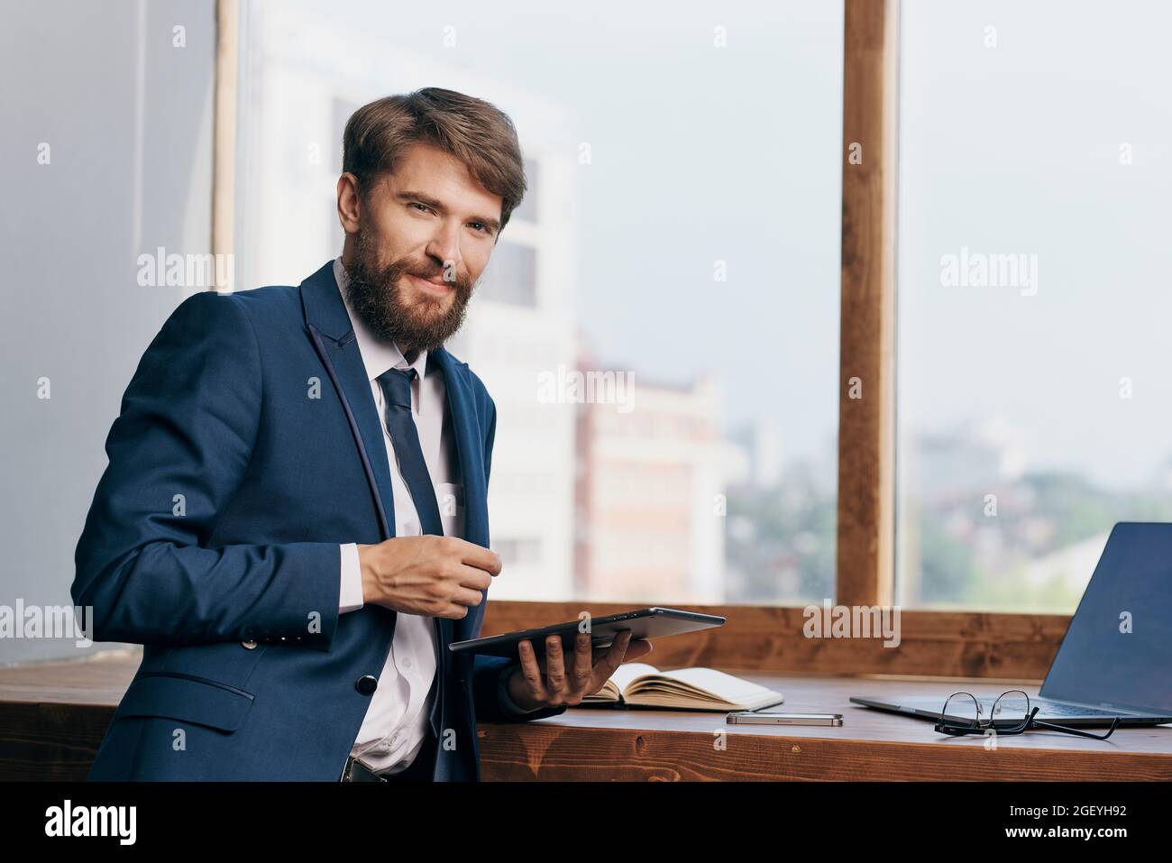 businessmen near the window with a laptop self-confidence Stock Photo ... businessmen near the window with a laptop self-confidence Stock Photo ...