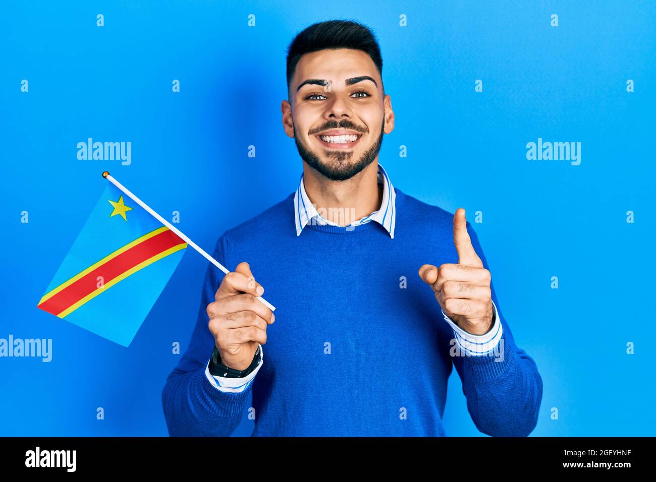 Young hispanic man with beard holding democratic republic of the congo ...