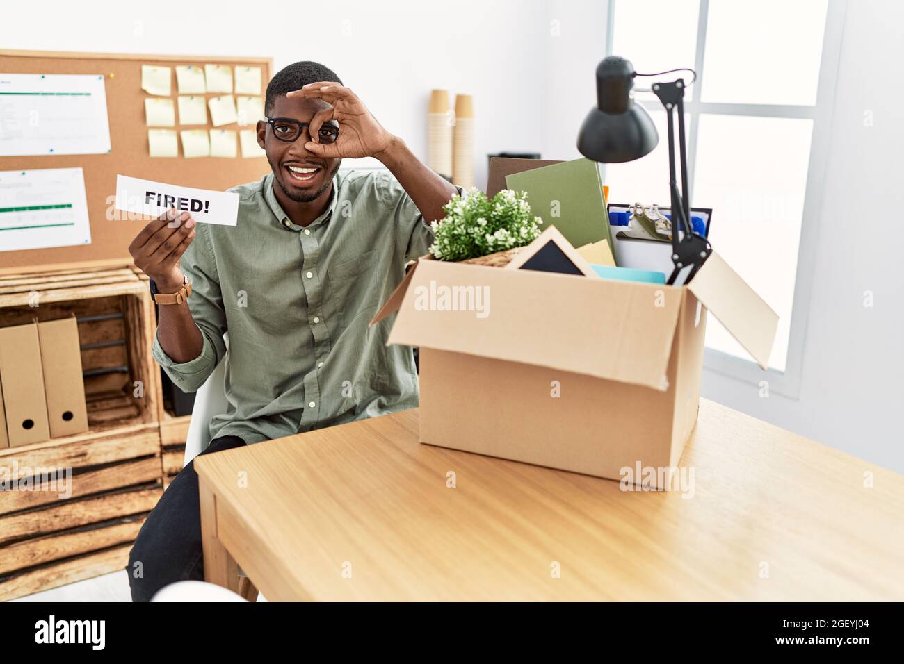 Young african american businessman holding fired banner at the office ...