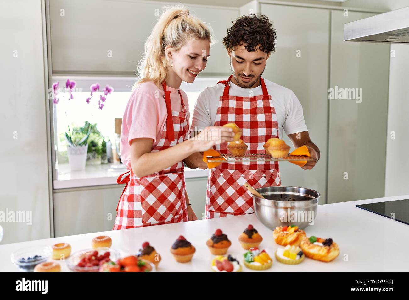 Young couple smiling happy cooking sweets at kitchen Stock Photo - Alamy