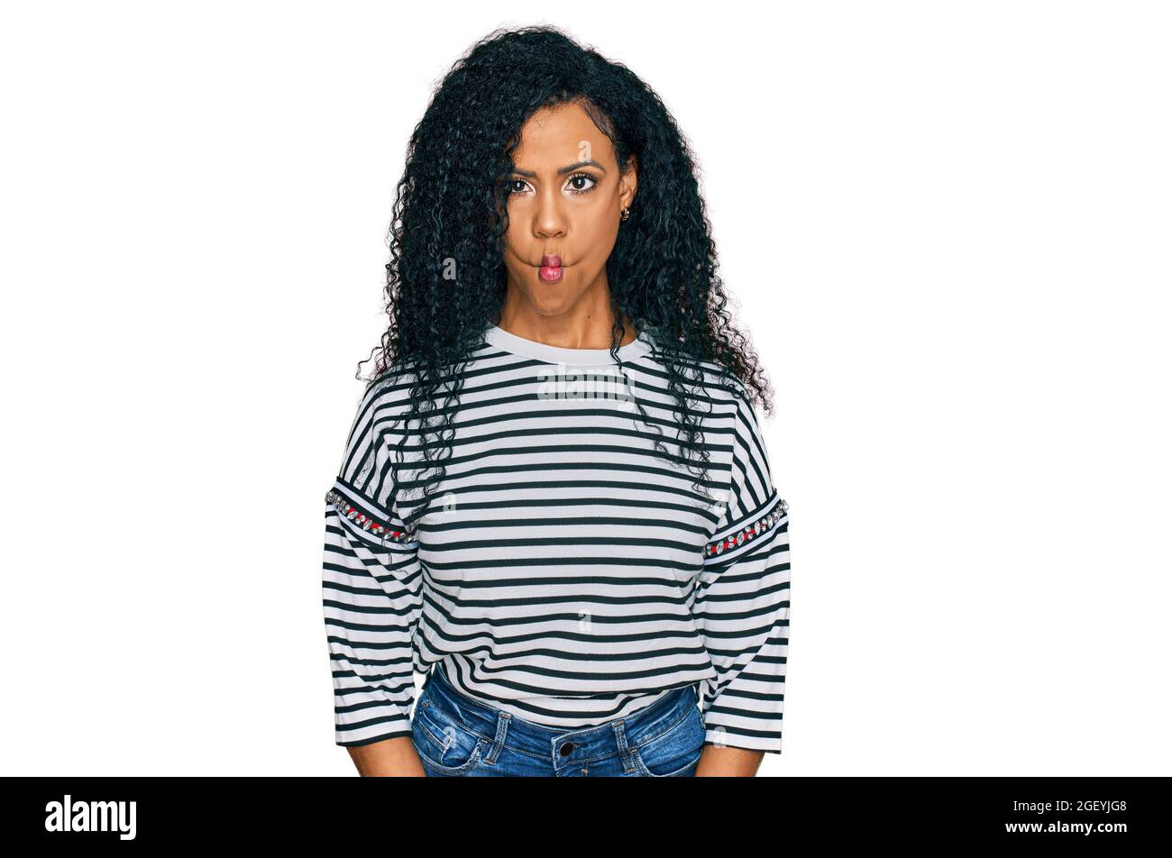 Middle age african american woman wearing casual clothes making fish ...