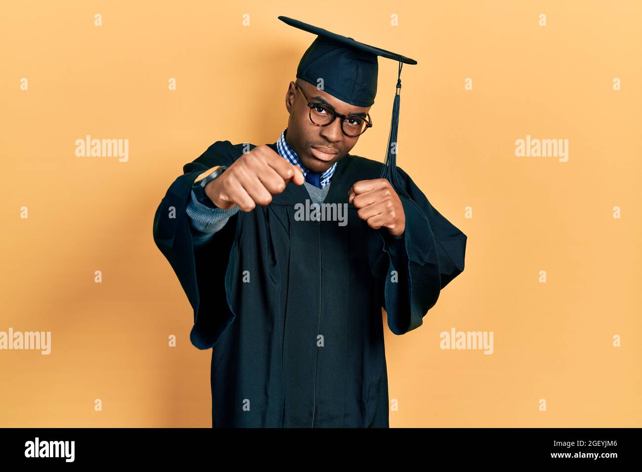 Young african american man wearing graduation cap and ceremony robe ...