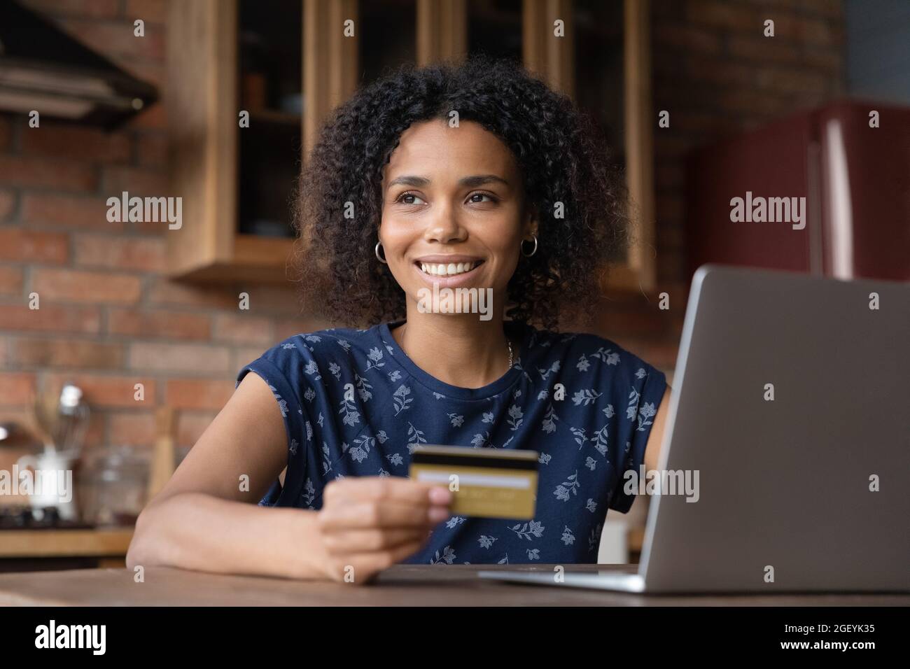 Happy African American shopper using computer and credit card Stock ...