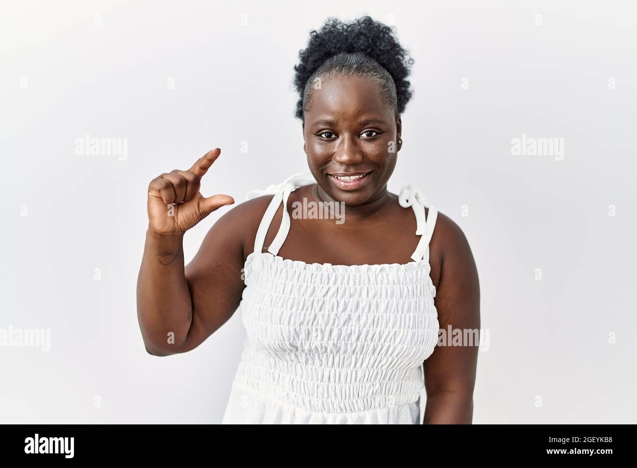 Young african woman standing over white isolated background smiling and ...