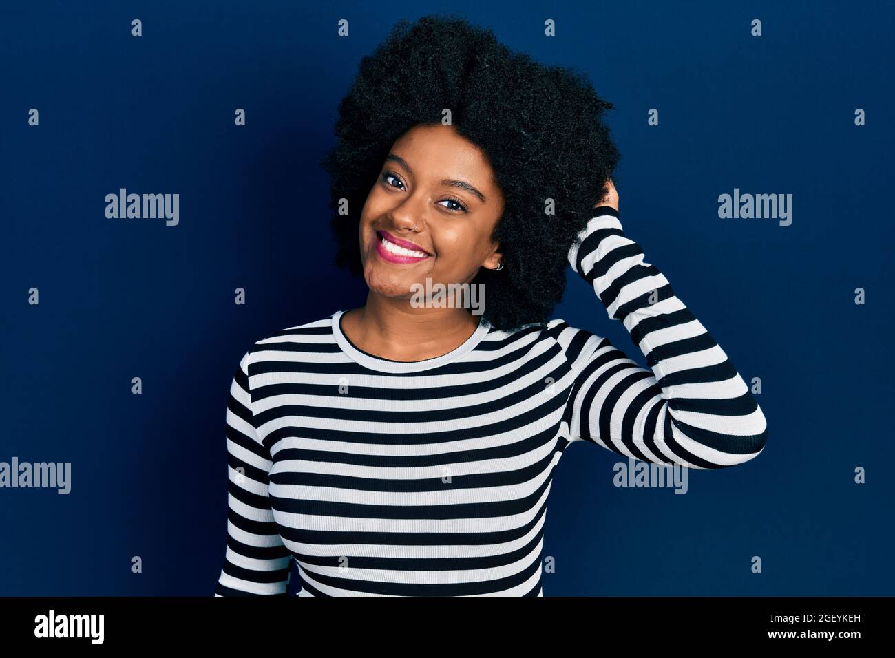 Young african american woman wearing casual clothes confuse and wonder ...