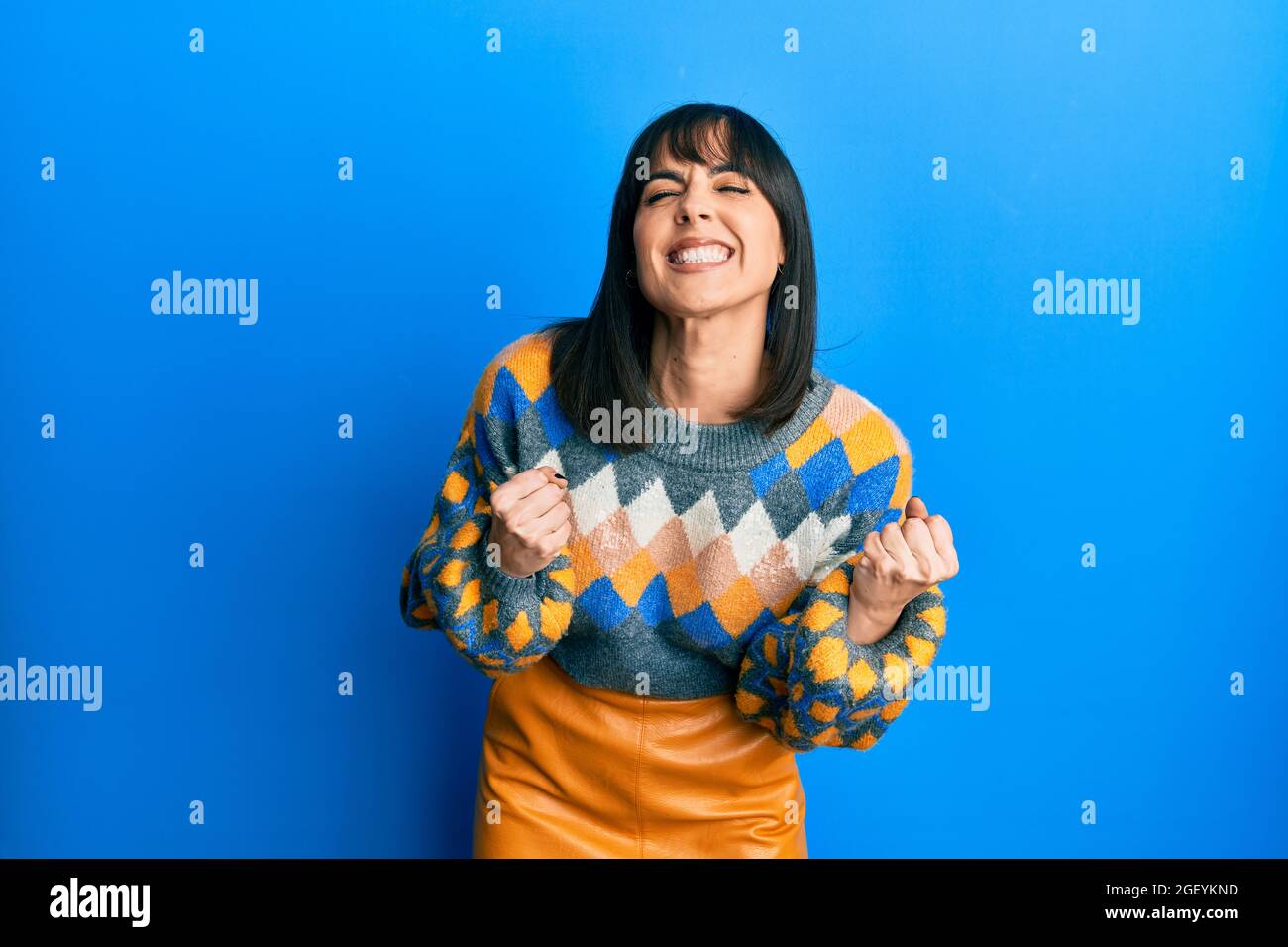 Young hispanic woman wearing casual winter sweater excited for success ...