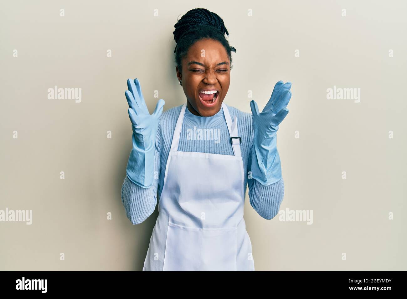 African american woman with braided hair wearing cleaner apron and ...