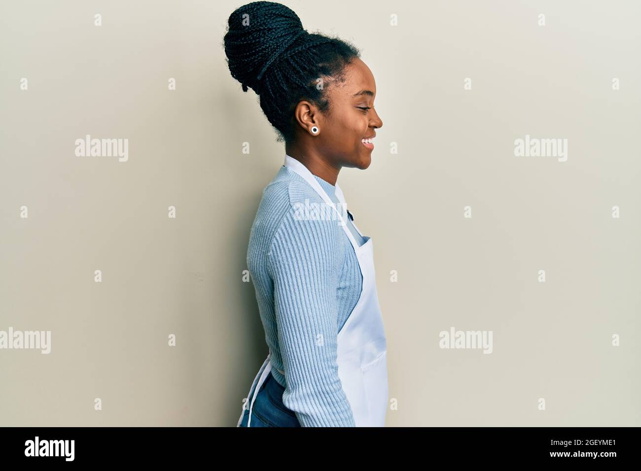 African american woman with braided hair wearing cleaner apron and ...