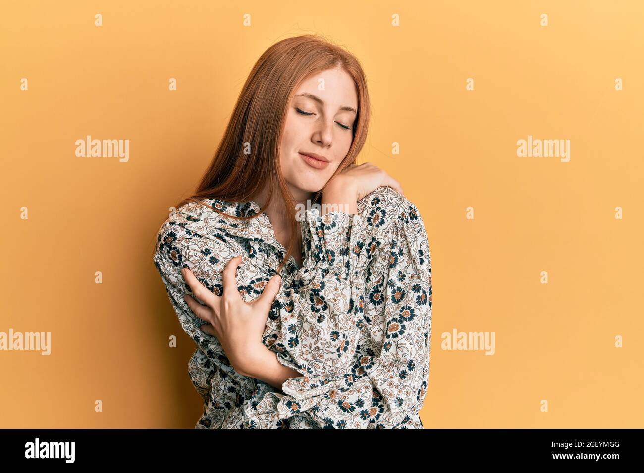 Young irish woman wearing casual clothes hugging oneself happy and ...