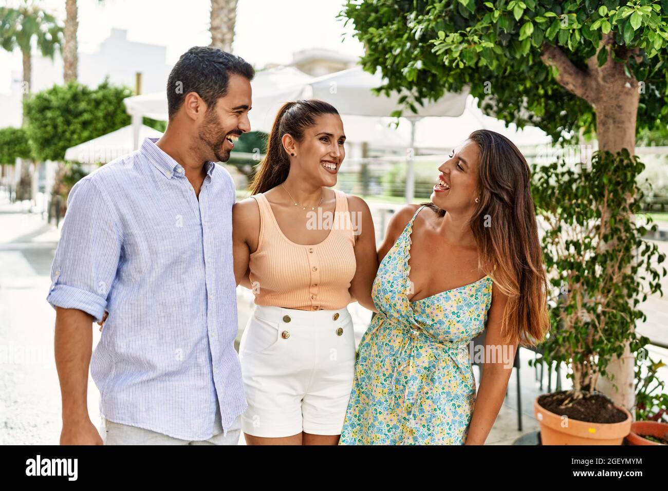 Three hispanic friends smiling happy and hugging at the city Stock ...