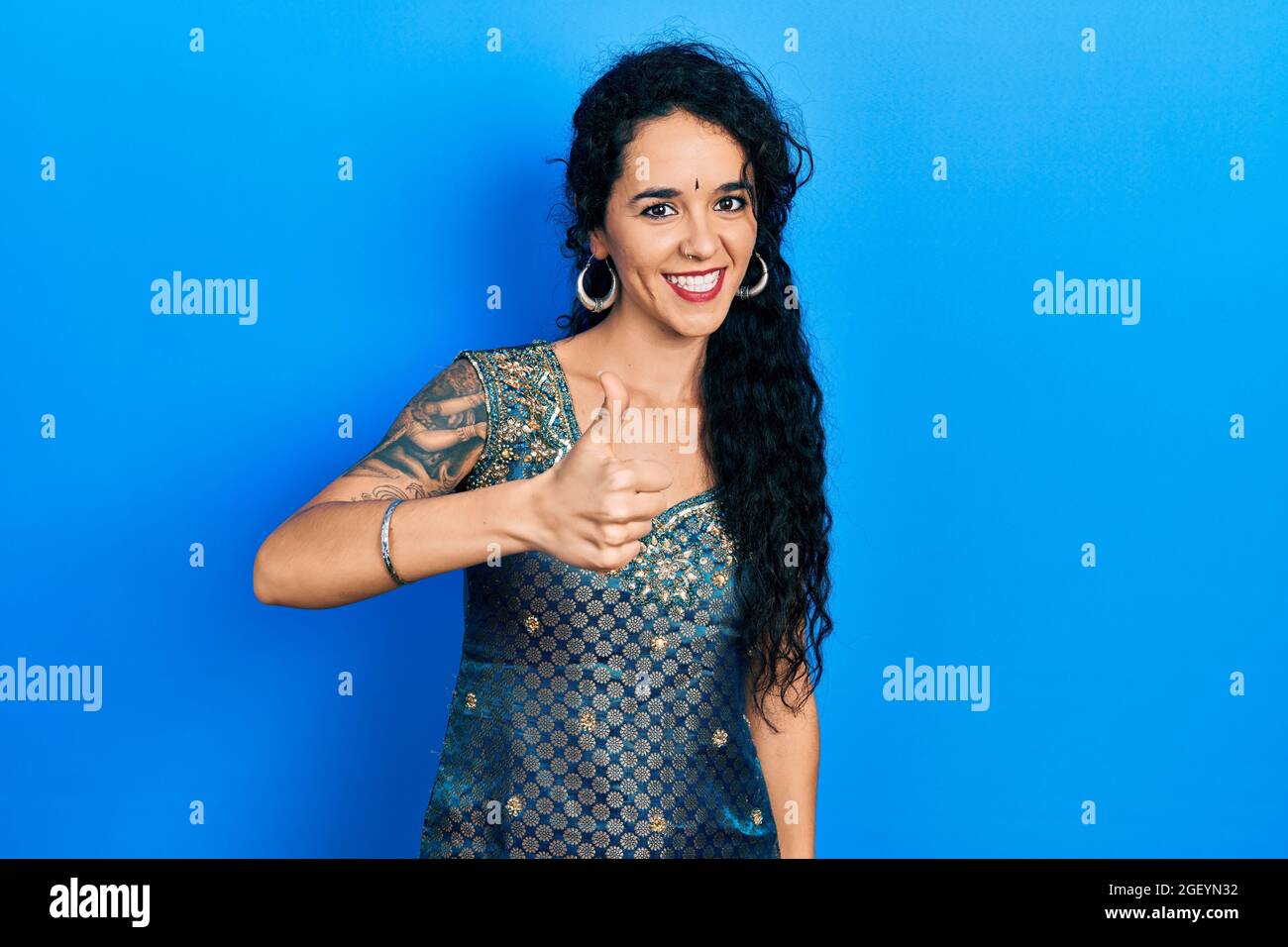 Young woman wearing bindi and traditional kurta dress doing happy ...