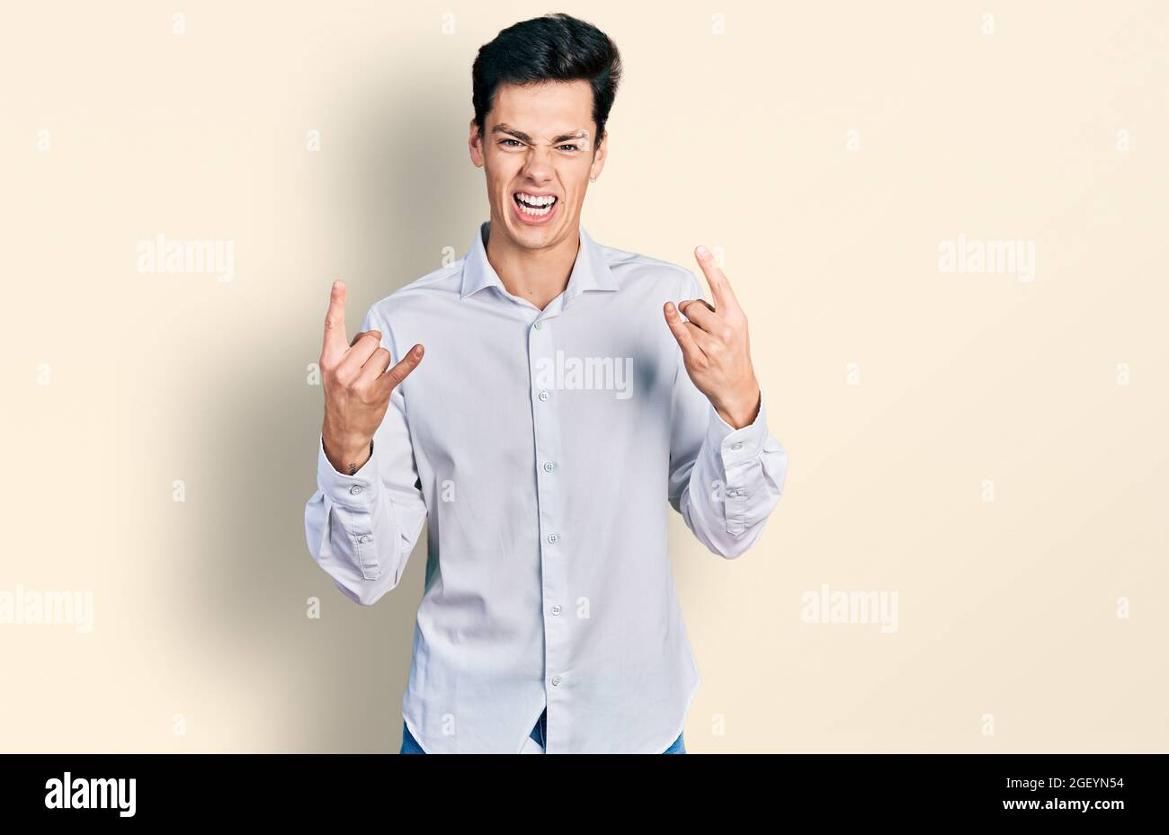 Young hispanic business man wearing business clothes shouting with ...