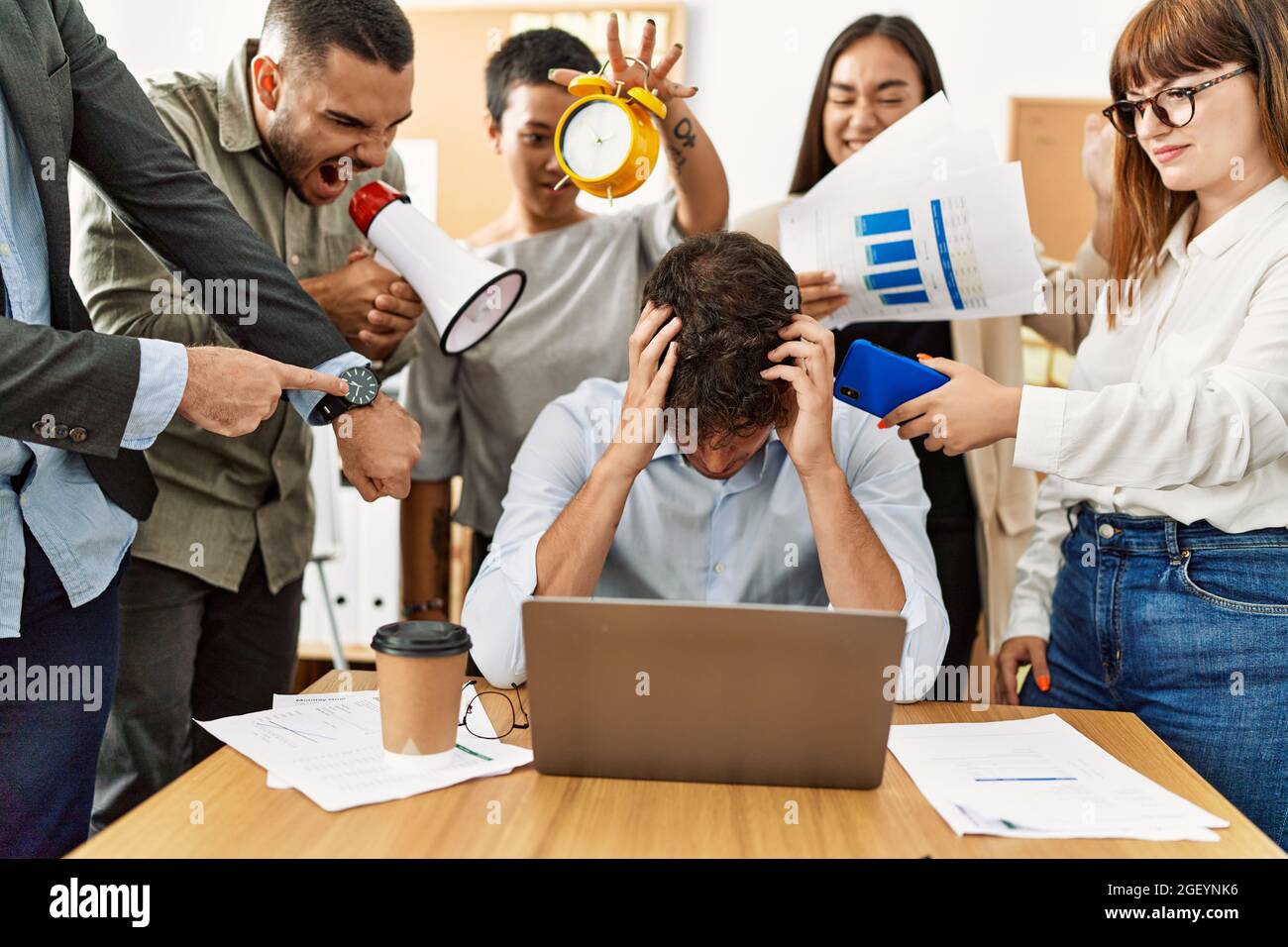 Group of business workers screaming to stressed partner at the office ...