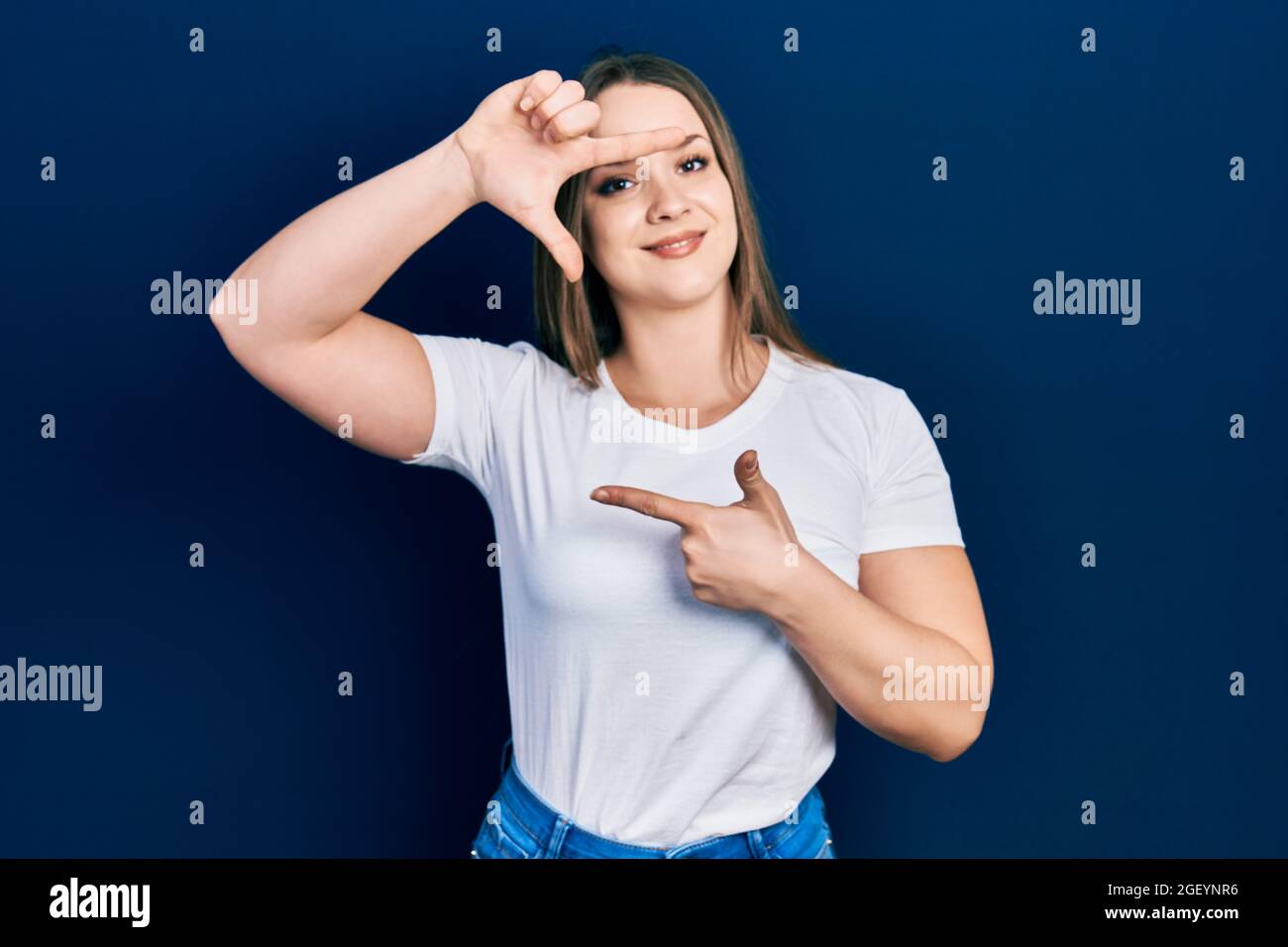 Young hispanic girl wearing casual white t shirt smiling making frame ...