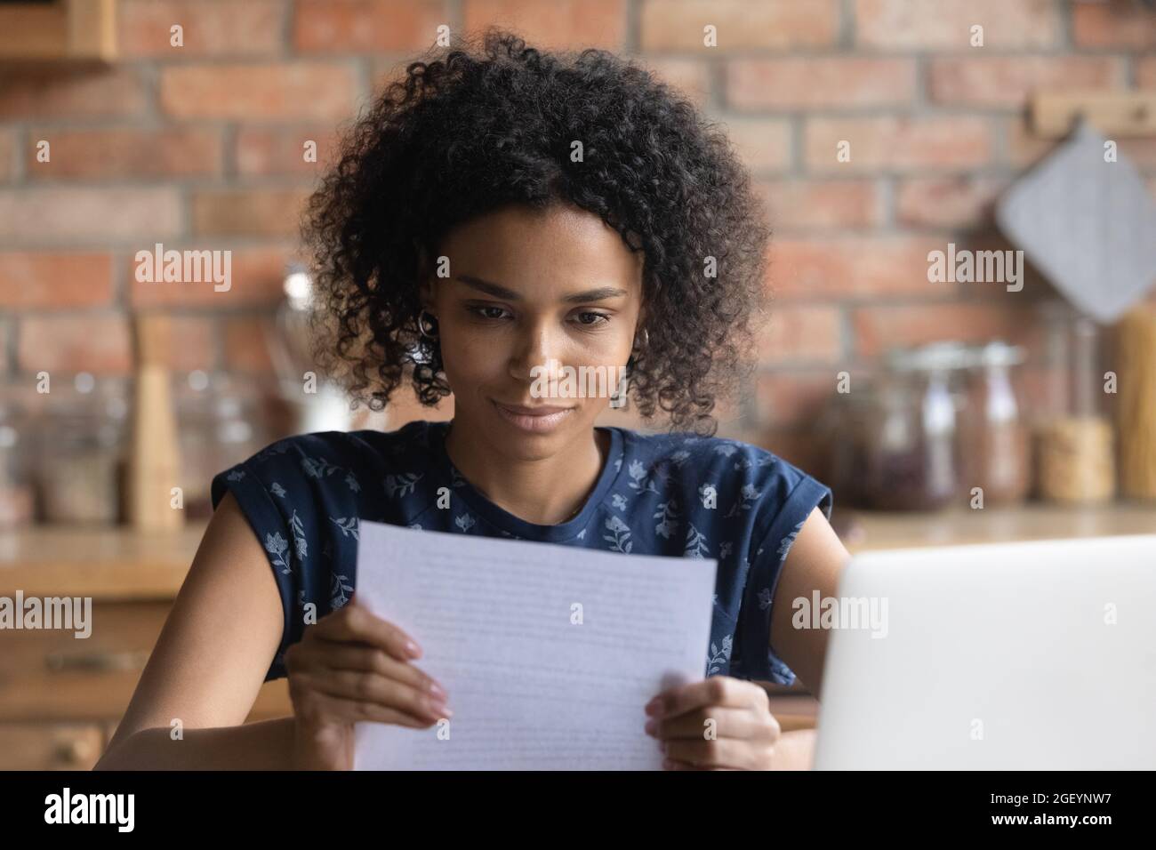 Focused Afro American student girl receiving important paper letter ...