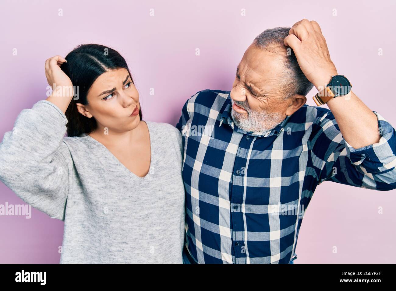 Hispanic father and daughter wearing casual clothes confuse and ...