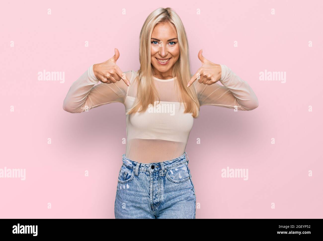 Young blonde woman wearing casual clothes looking confident with smile ...